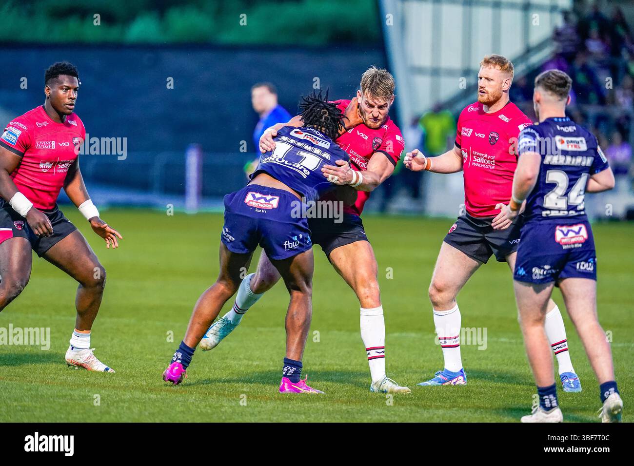 SALFORD, ENGLAND - MAY 30: Junior Nsemba of Wigan Warriors is tackled by Chris Hankinson of ...