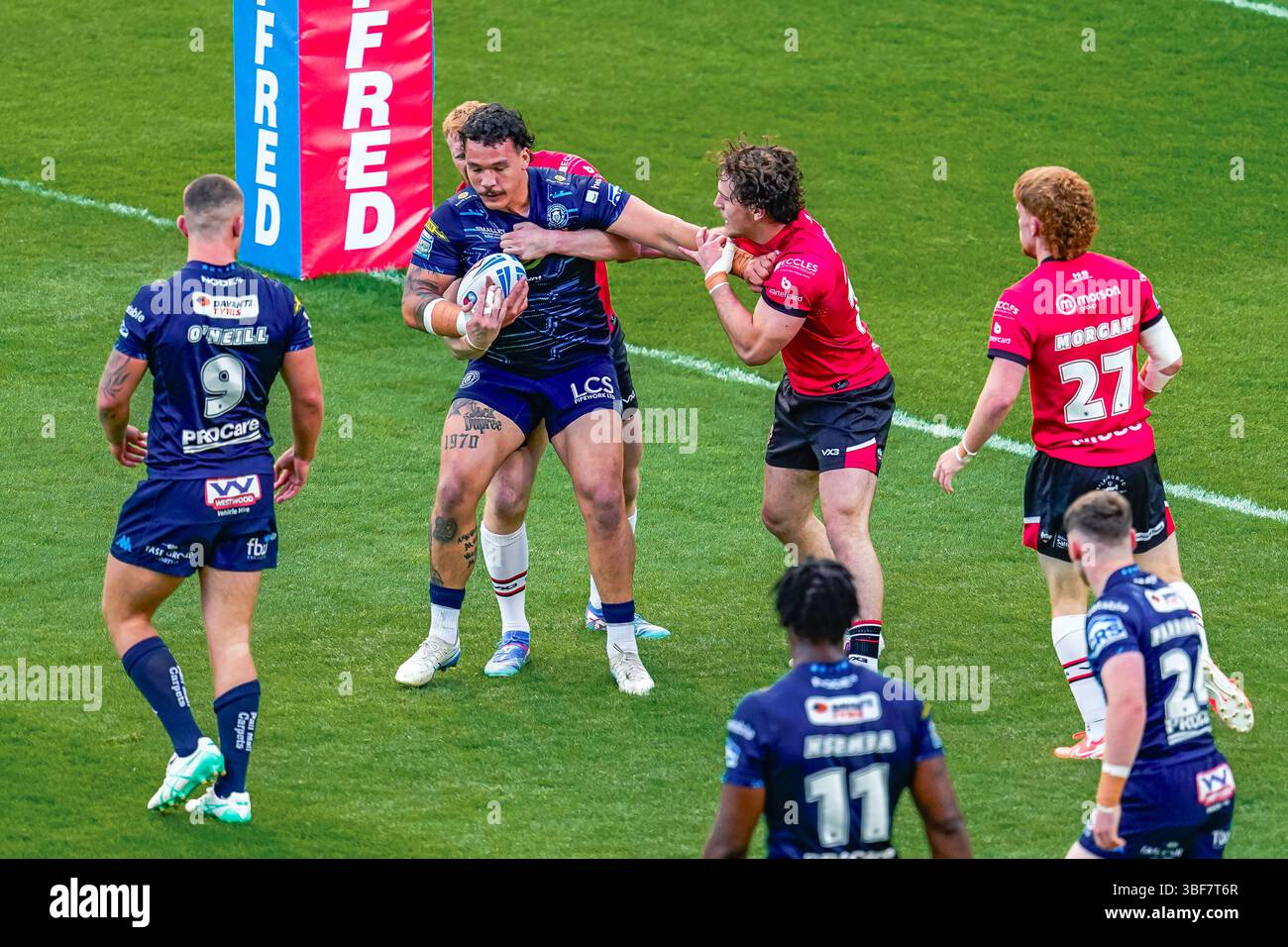 SALFORD, ENGLAND - MAY 30: Tyler Dupree of Wigan Warriors is tackled by ...
