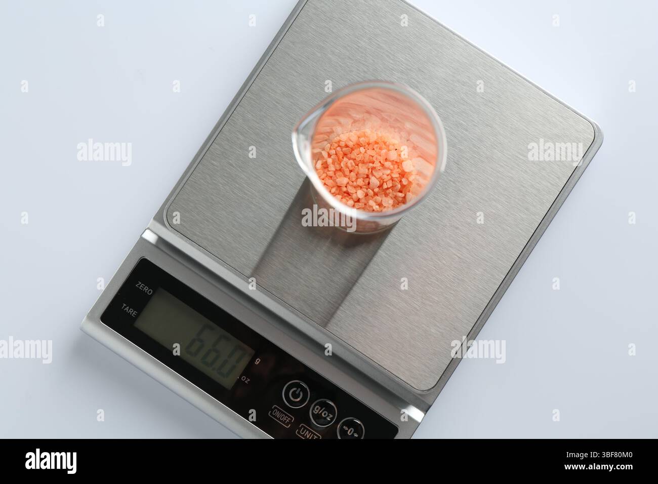 Laboratory scale with beaker of sample on white background, top view ...