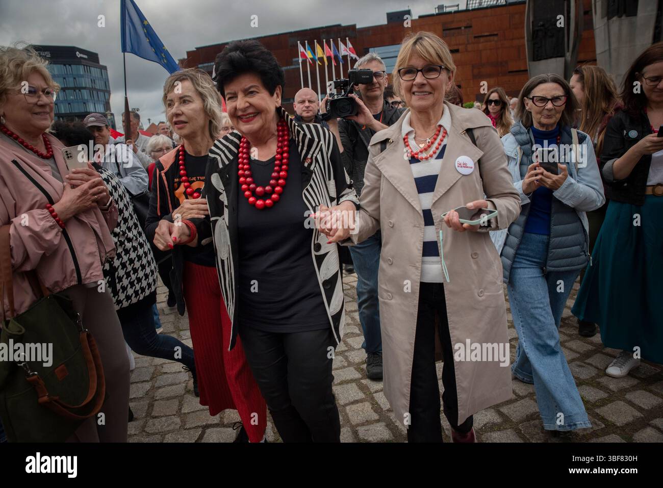 Professor Joanna Senyszyn walks surrounded by women before the start of ...