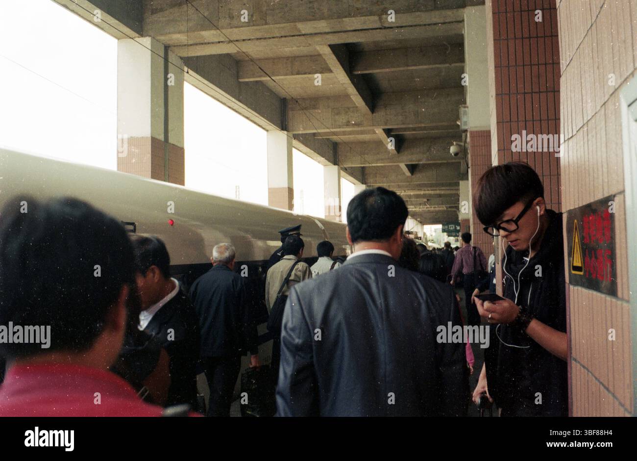Passengers Boarding at a Chinese Train Station Platform with Modern ...