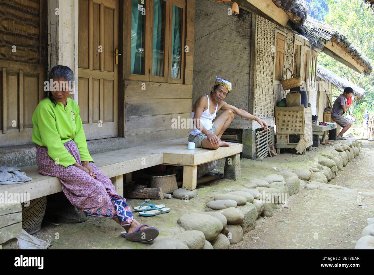 Daily life of Kampung Naga resident, chatting on veranda. Traditional ...