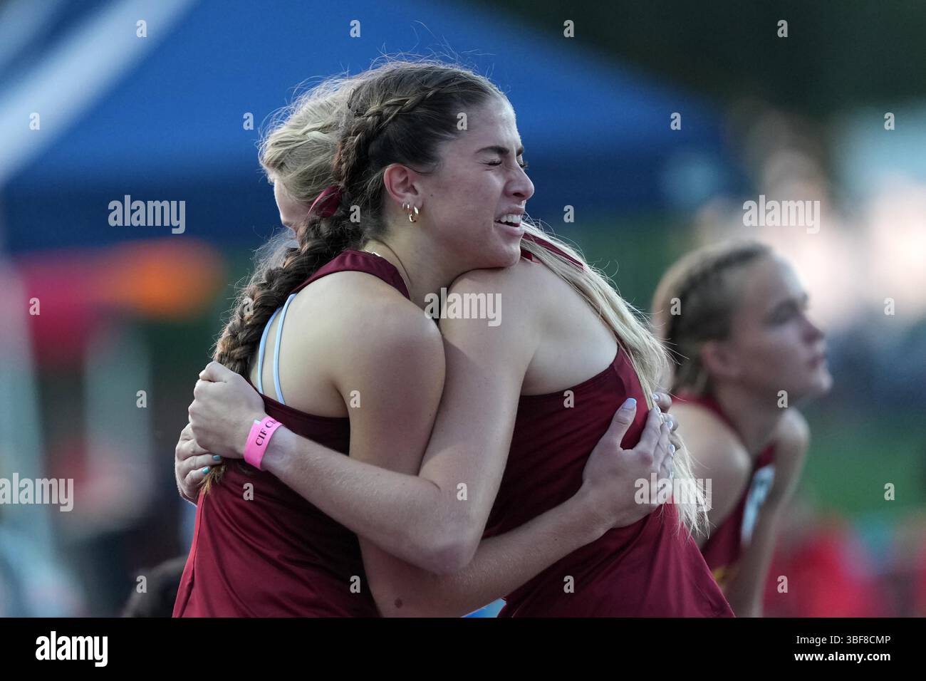 Anne Elise Packard (right) and Chloe Elbaz of JSerra embrace after placing first and second in ...