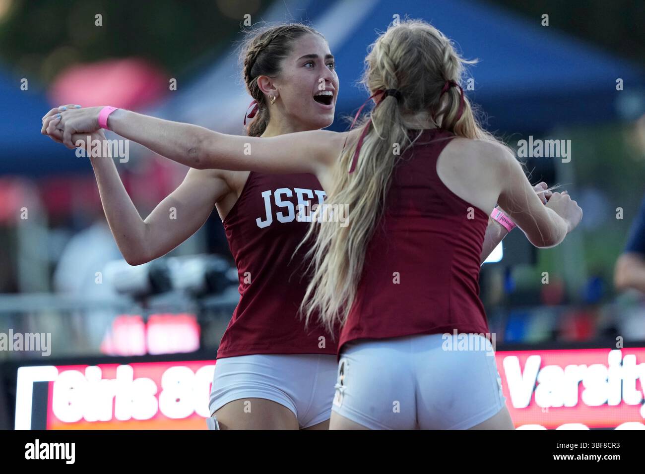 Anne Elise Packard (right) and Chloe Elbaz of JSerra embrace after placing first and second in ...