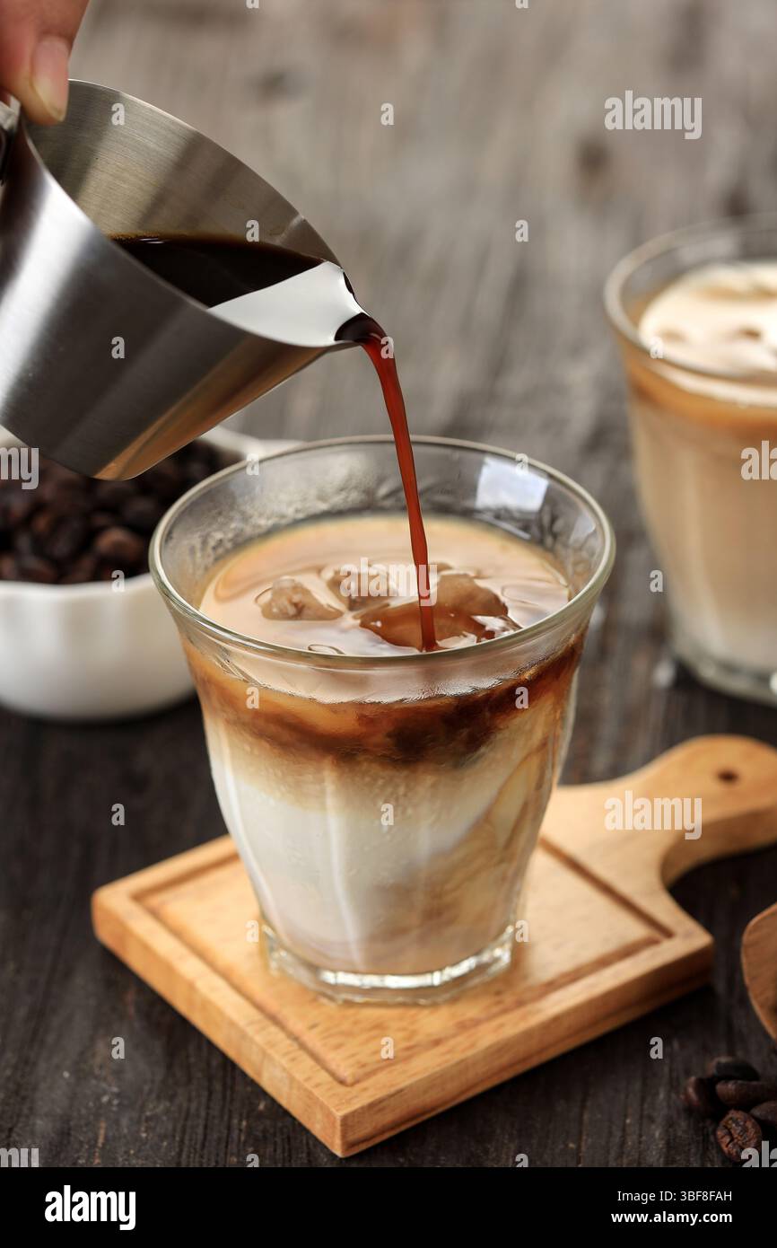 Pour Espresso to the Glass with Iced Fresh Milk, Process making Es Kopi ...
