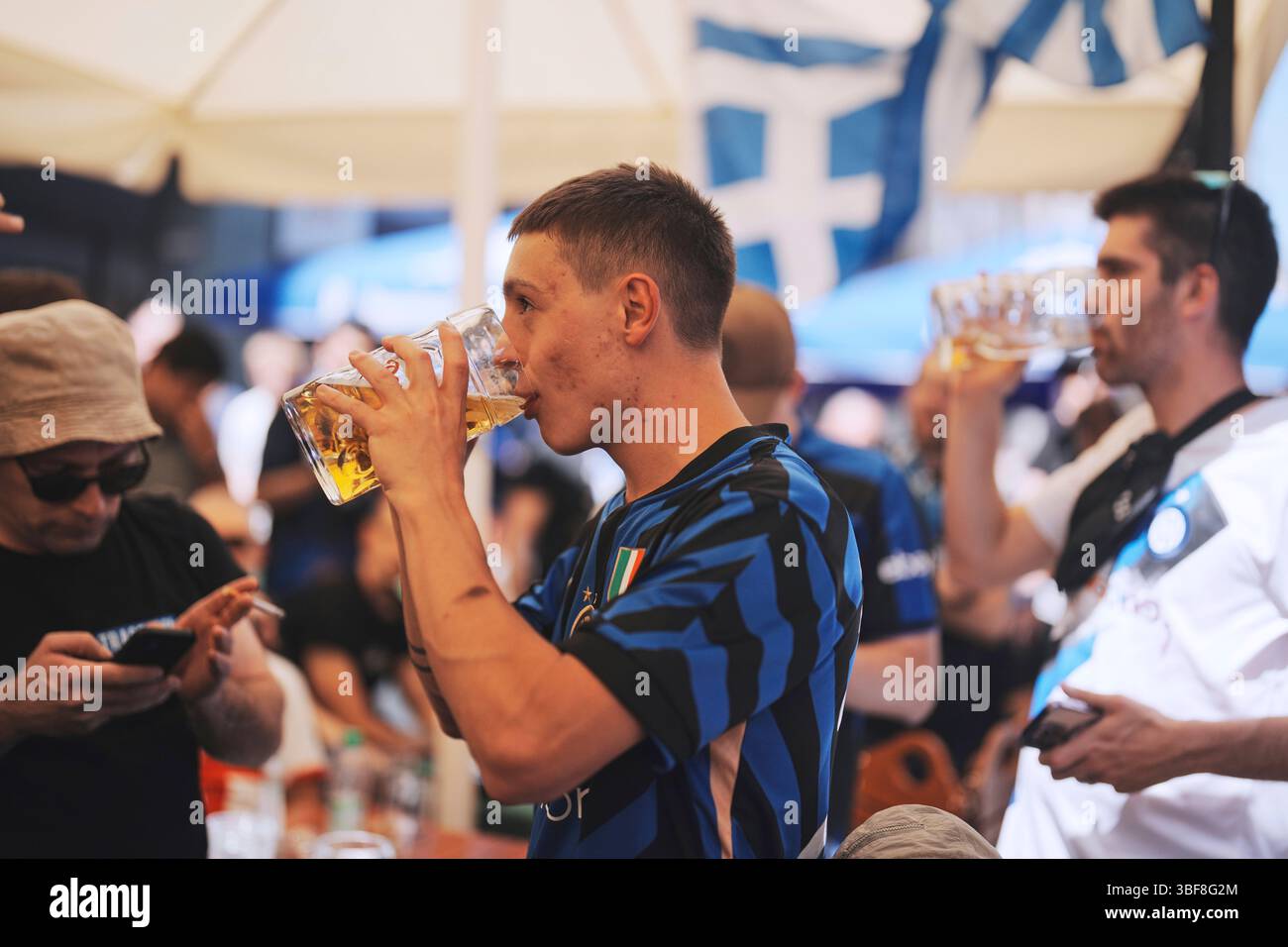 Inter fans drink a beer in the city center ahead of the Champions ...