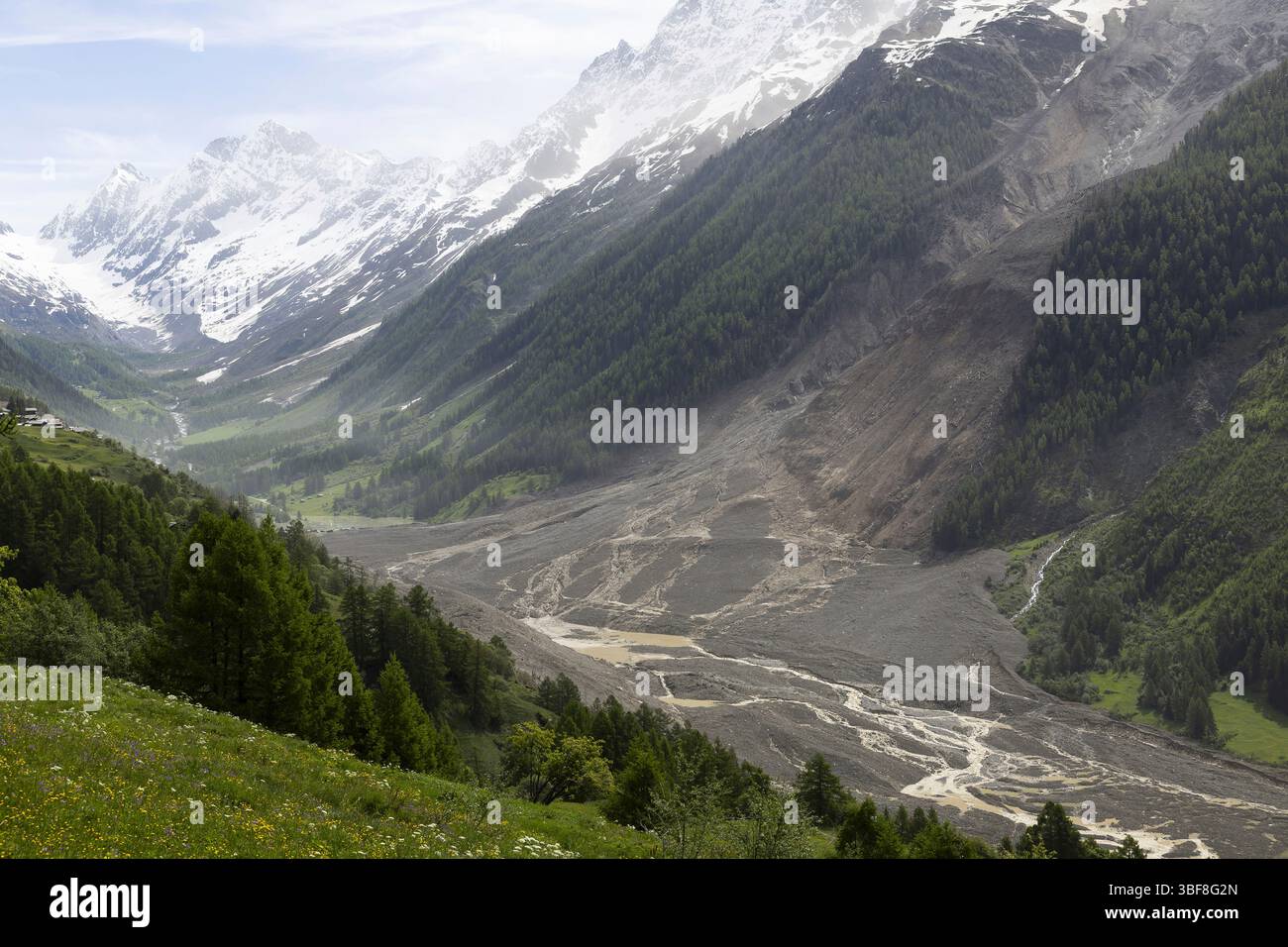 Water from the Lonza river flows over the mud and stone, after the ...