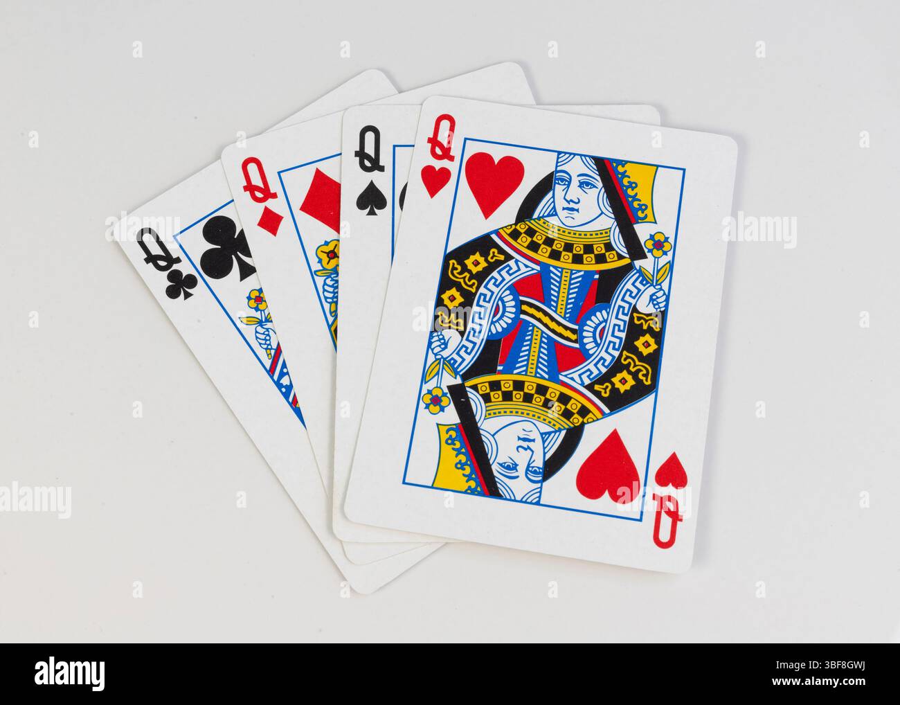 Four queens playing cards of hearts, spades, diamonds and clubs on ...