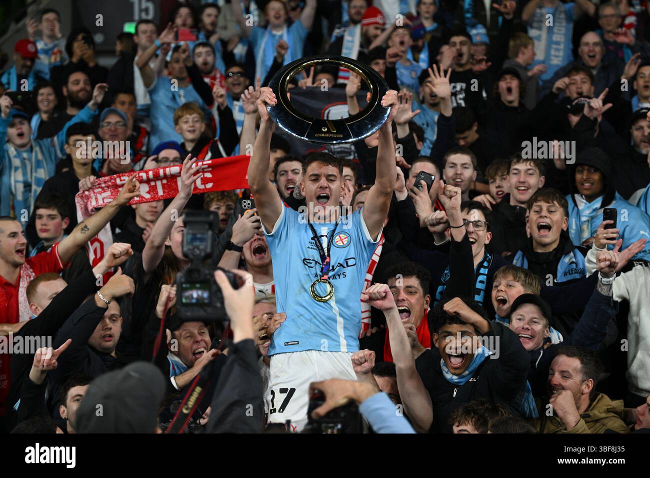 Max Caputo of Melbourne City lifts the trophy after defeating Melbourne ...