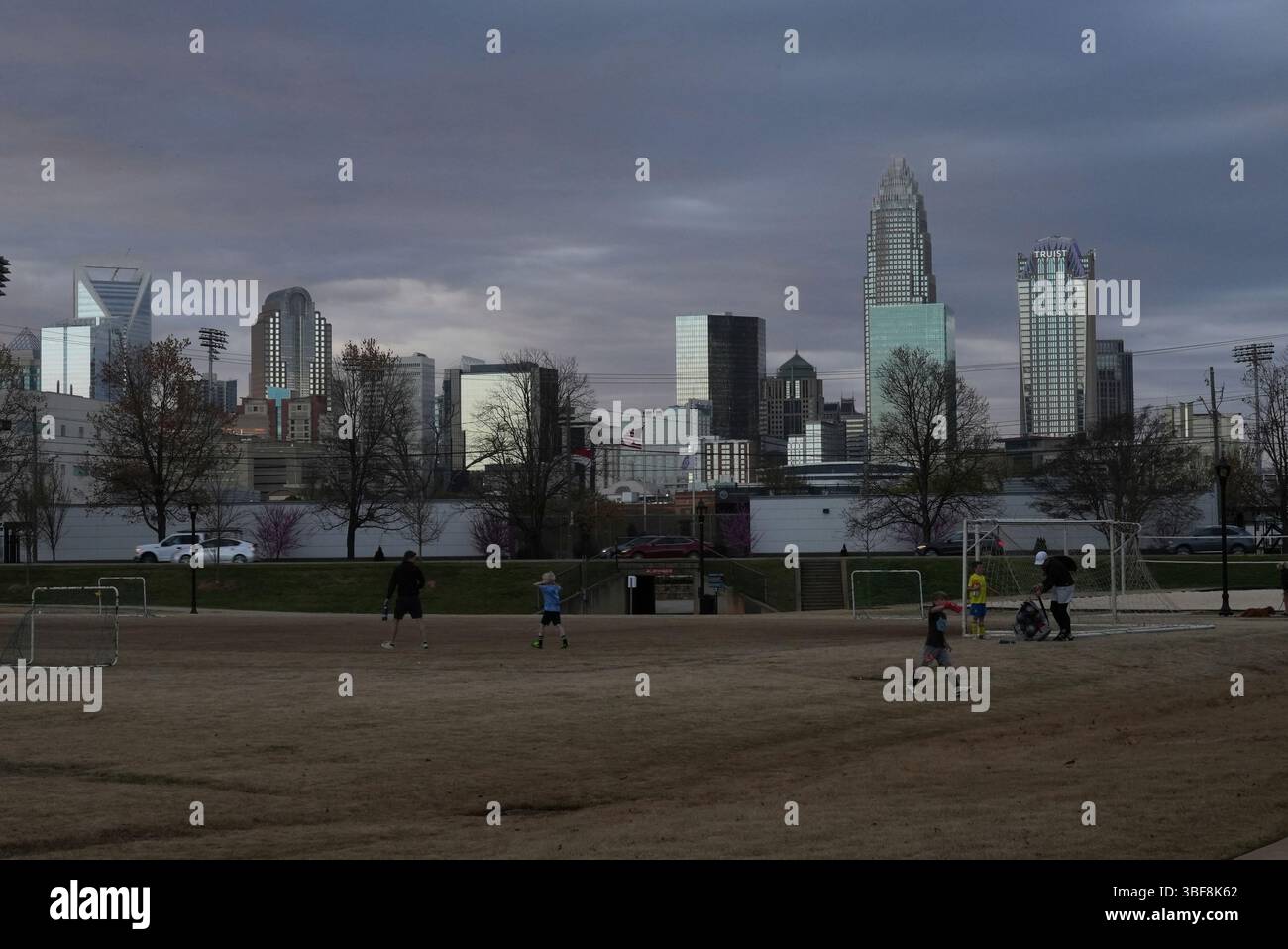 Children walk through a sports field in Independence Park under the ...