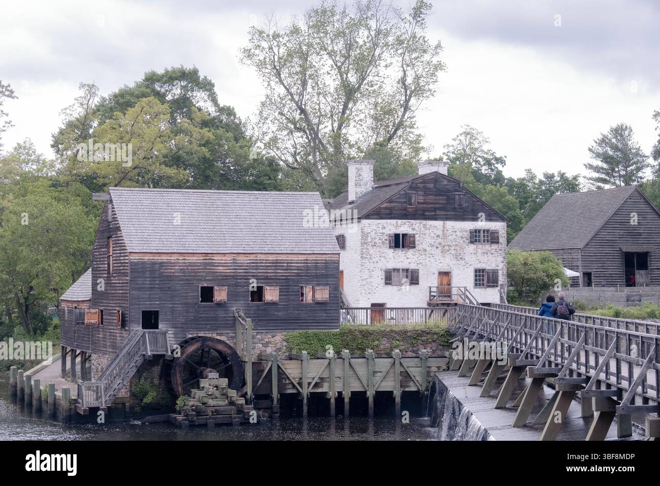 Tourists cross the millpond bridge to the Philipsburg Manor, where an ...