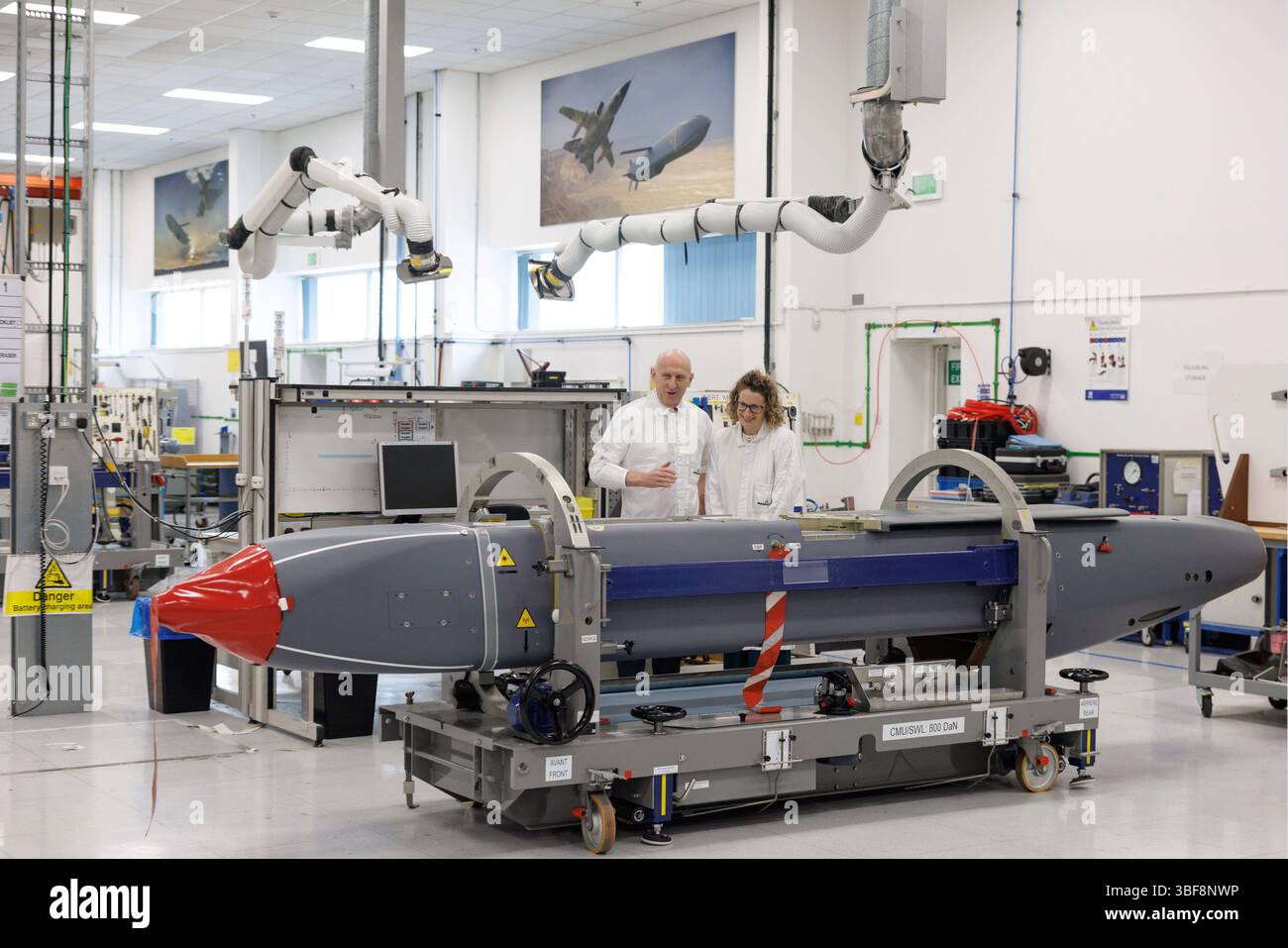Louise Holmes, MBDA UK Deputy Managing Director, shows Britain's Defence Secretary John Healey ...