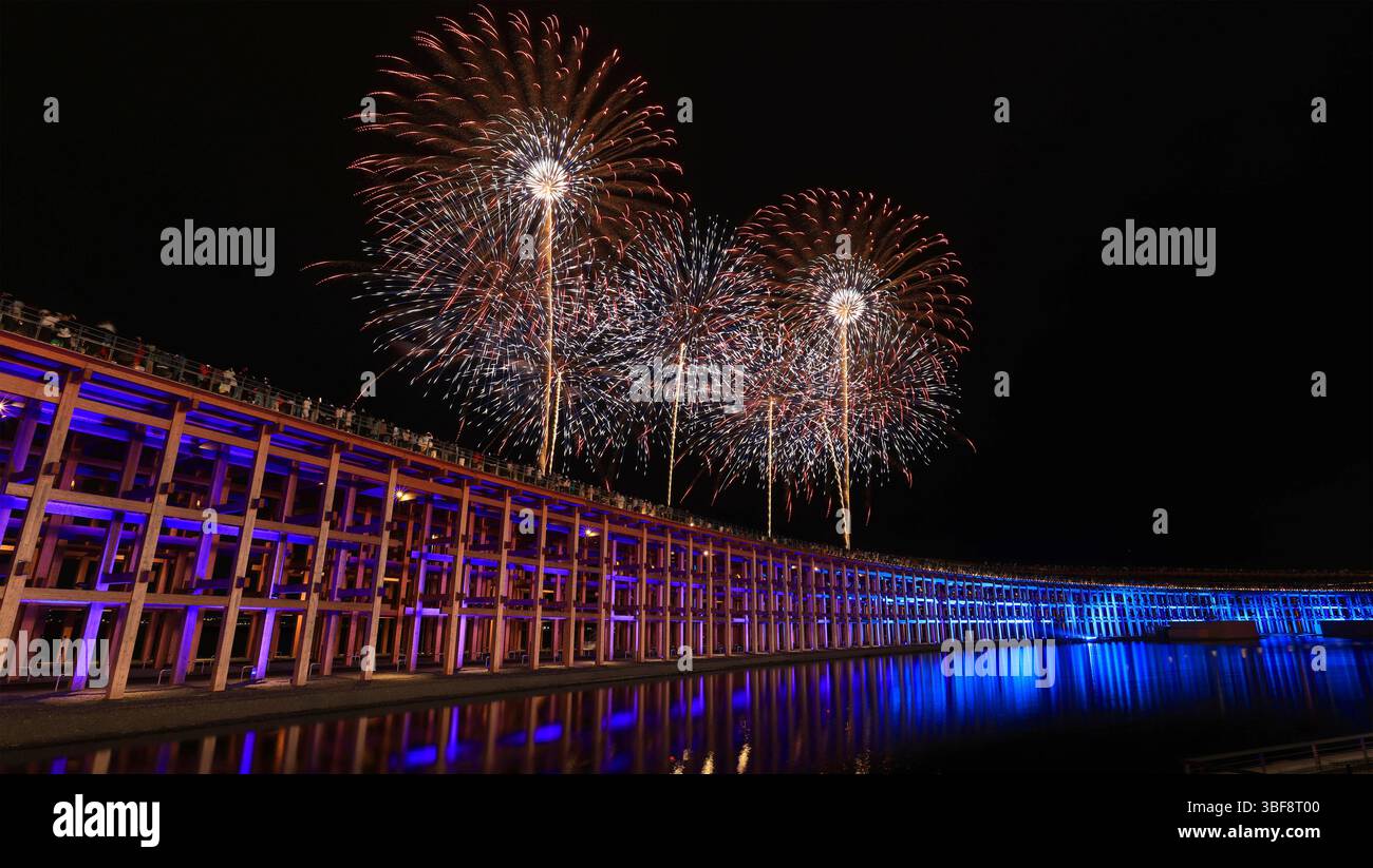 A 8-second exposure photograph captures fireworks coloring the night ...