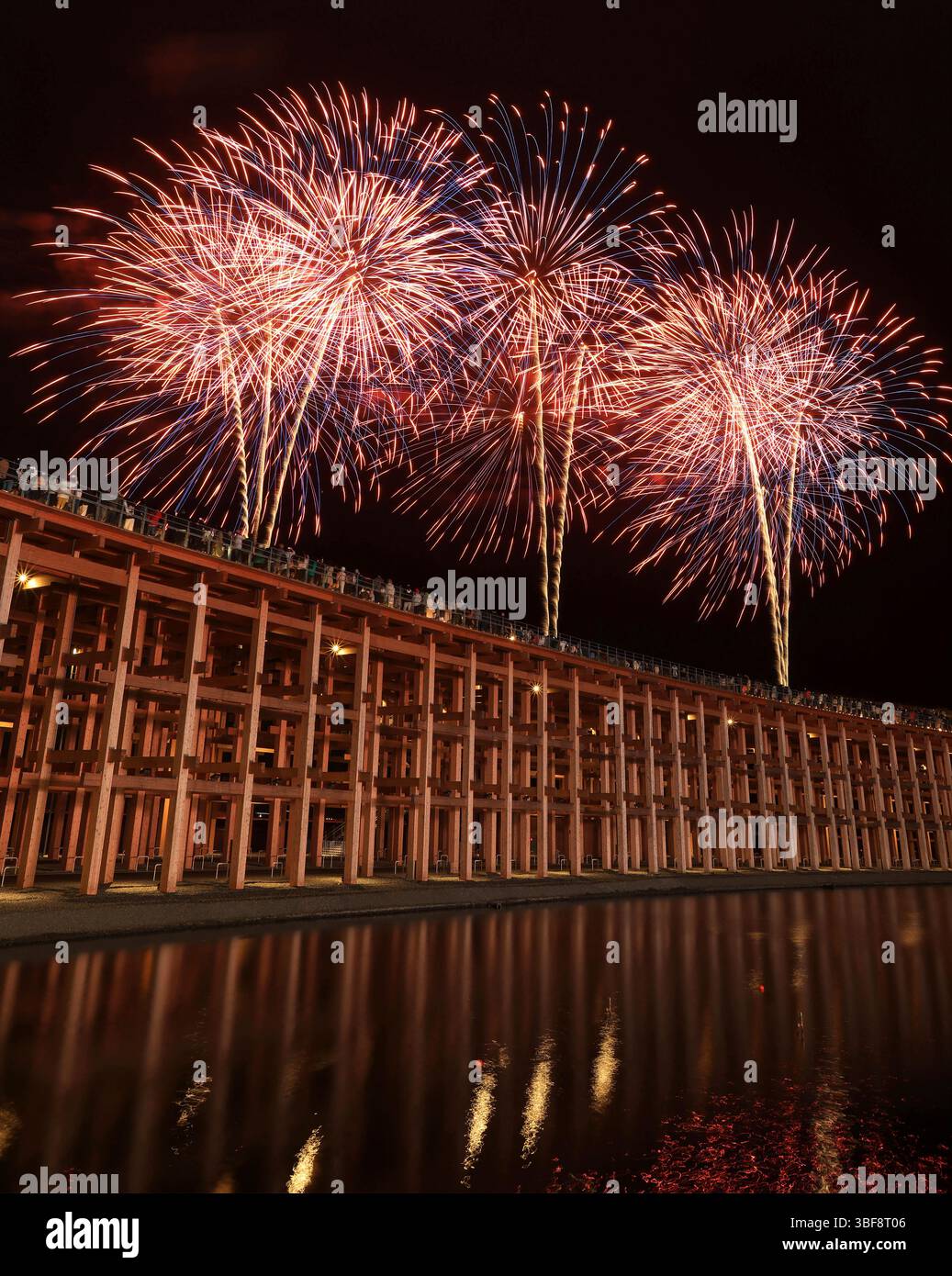 A 10-second exposure photograph captures fireworks coloring the night ...