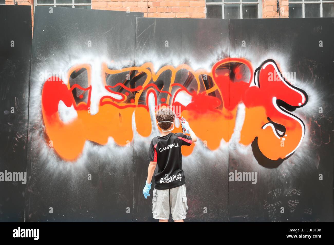 Birmingham, UK. 31st May, 2025. A young boy shows off his graffiti ...