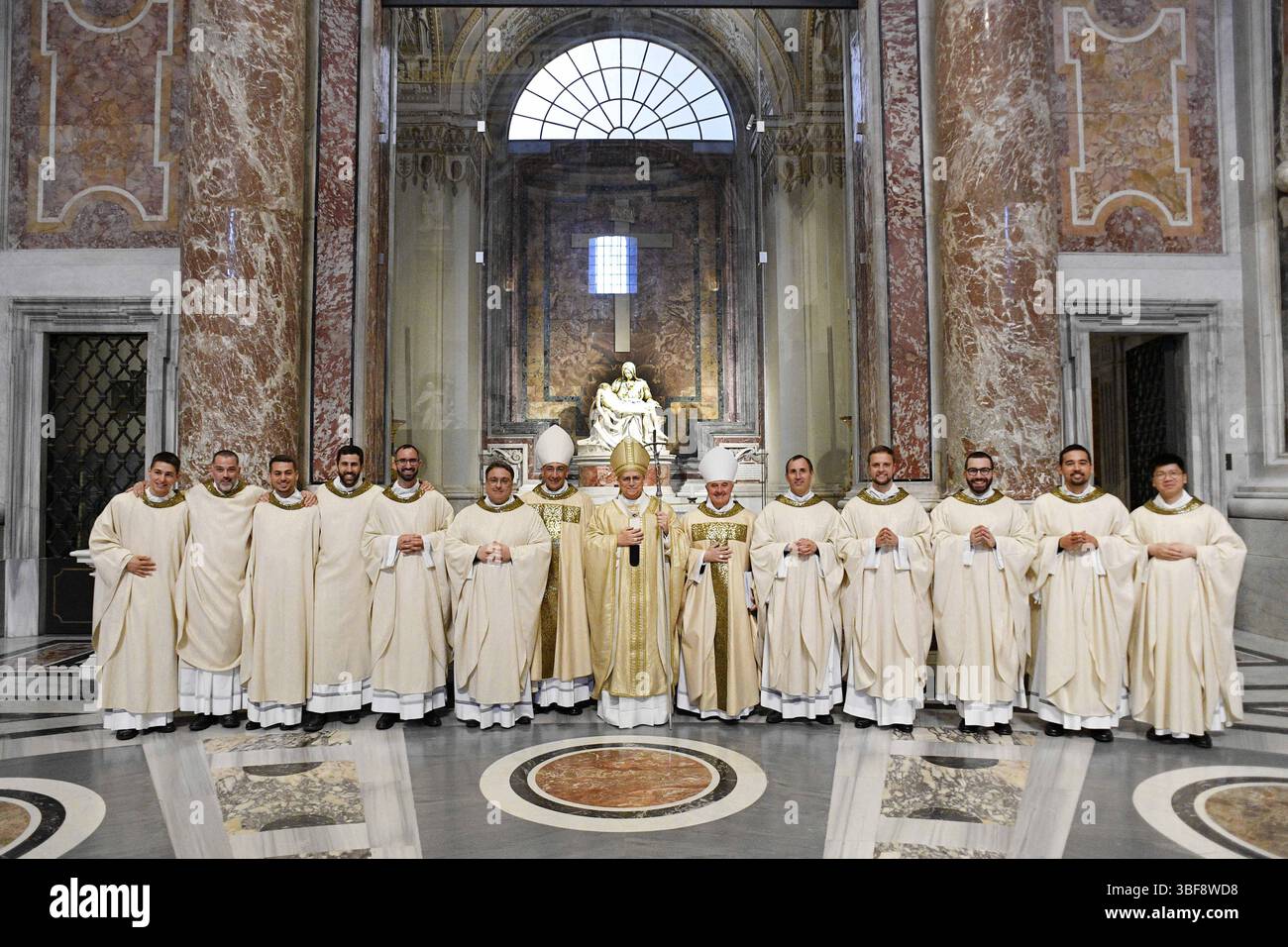Pope Leo XIV poses with the new priests in front of Michelangelo’s ...