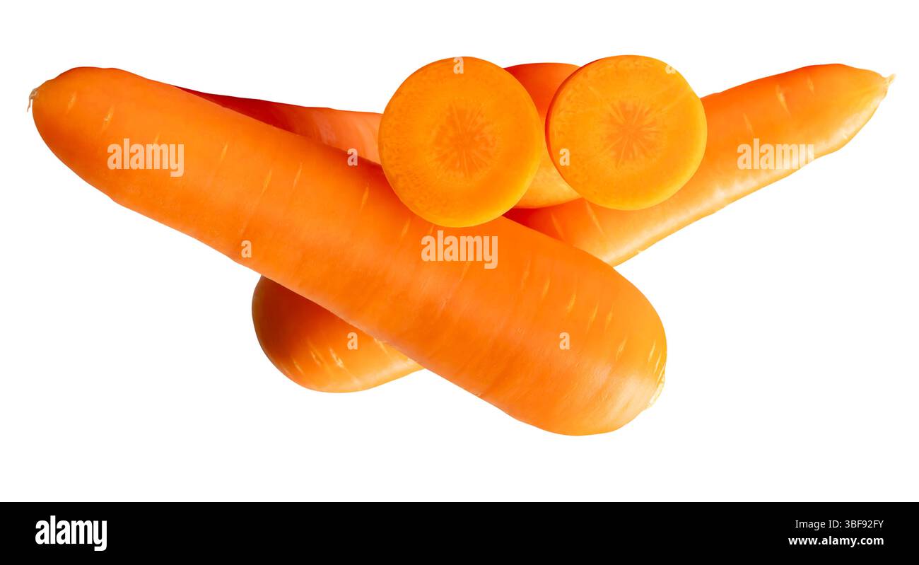 Side view of three fresh orange carrot roots with slices in circles in ...