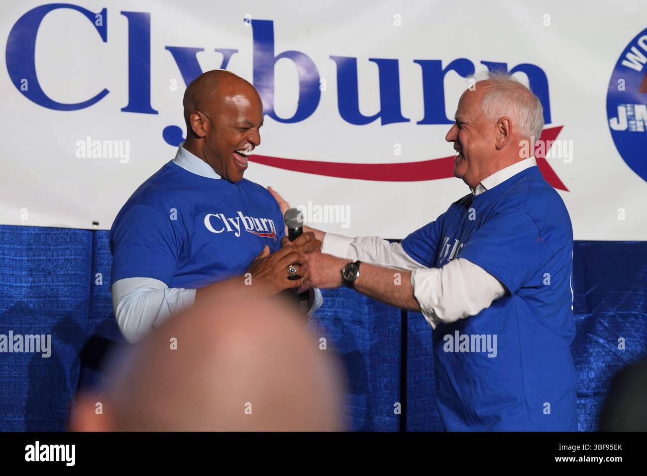 Minnesota Gov. TIm Walz, right, hands the microphone to Maryland Gov ...