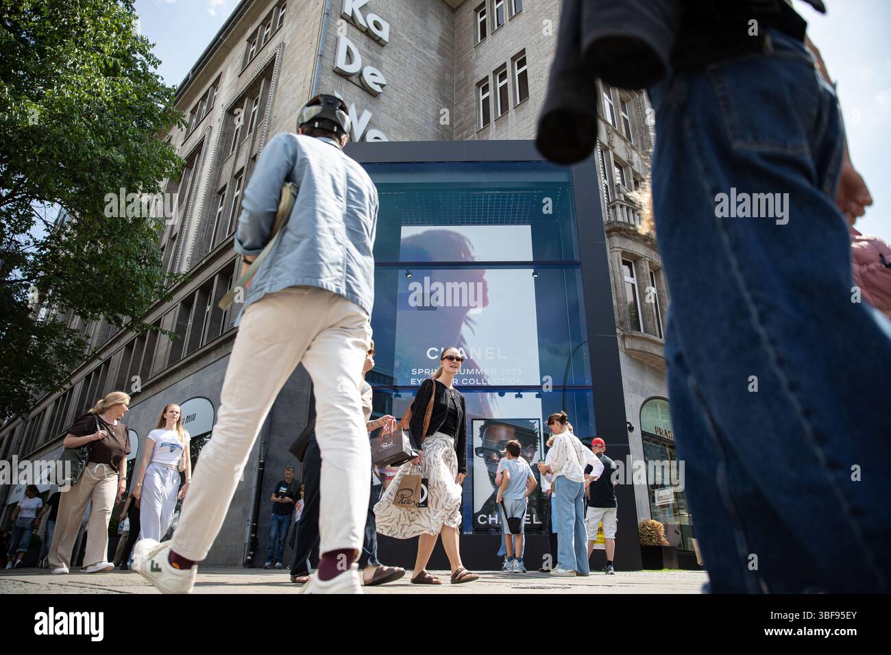 People walk past the upscale KaDeWe department store in Berlin, Germany ...