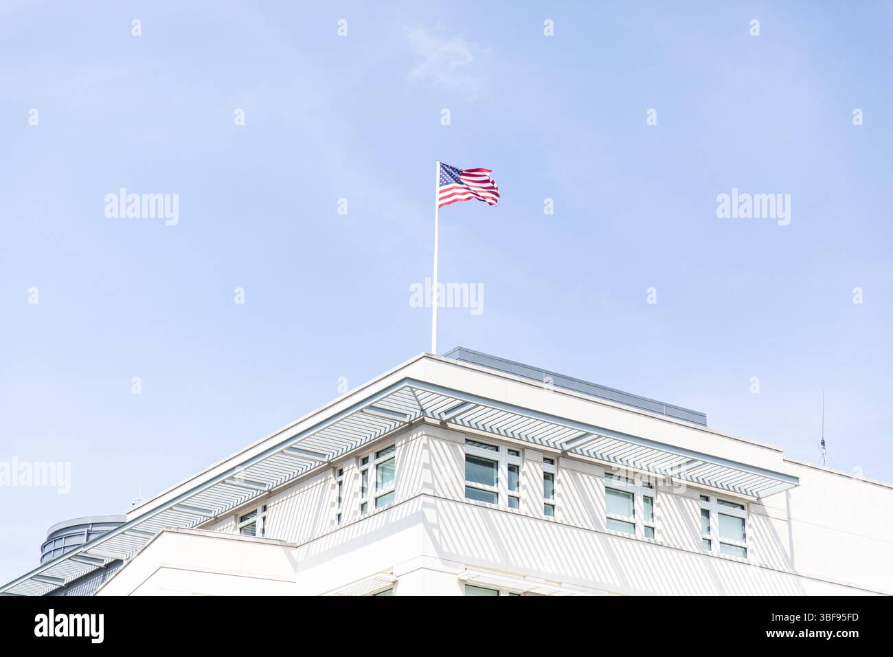 The U.S. flag flies atop the United States Embassy in Berlin, Germany ...
