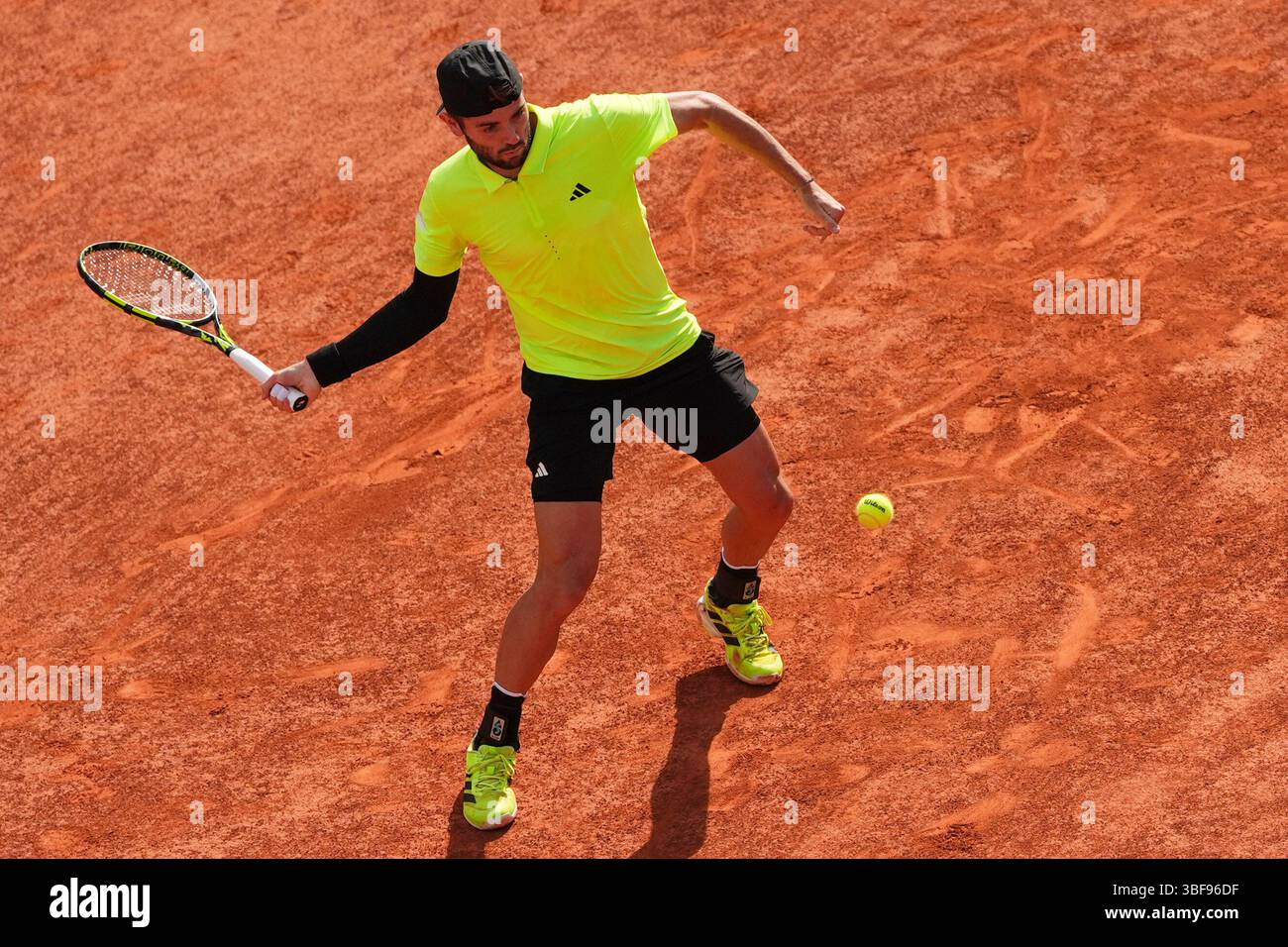 Britain's Jacob Fearnley returns the ball to Britain's Cameron Norrie ...