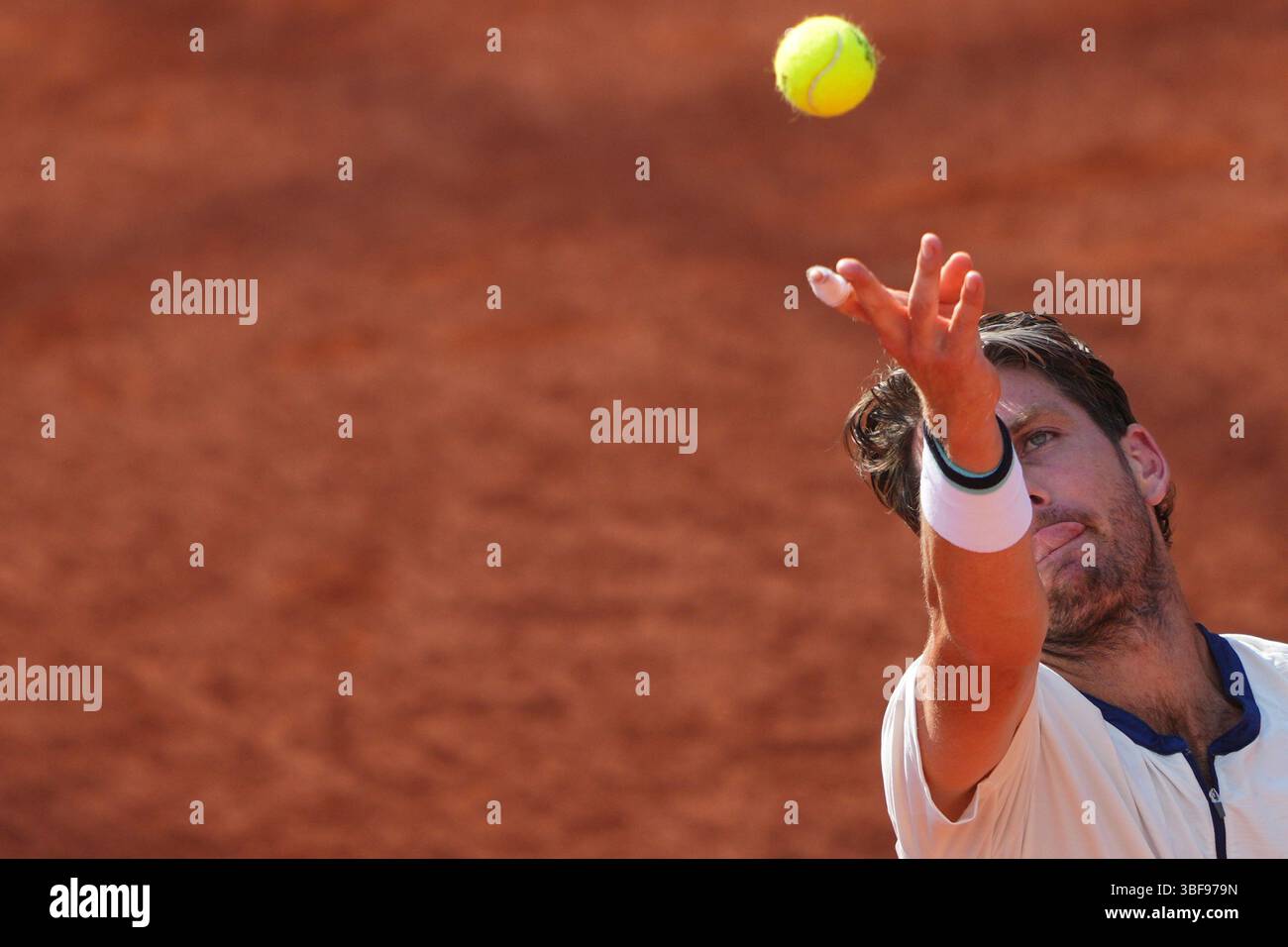 Britain's Cameron Norrie serves against Britain's Jacob Fearnley during ...