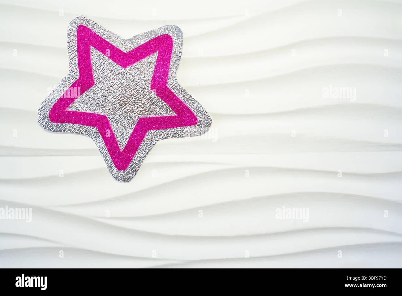 A sparkling star shape features a metallic silver surface with pink ...