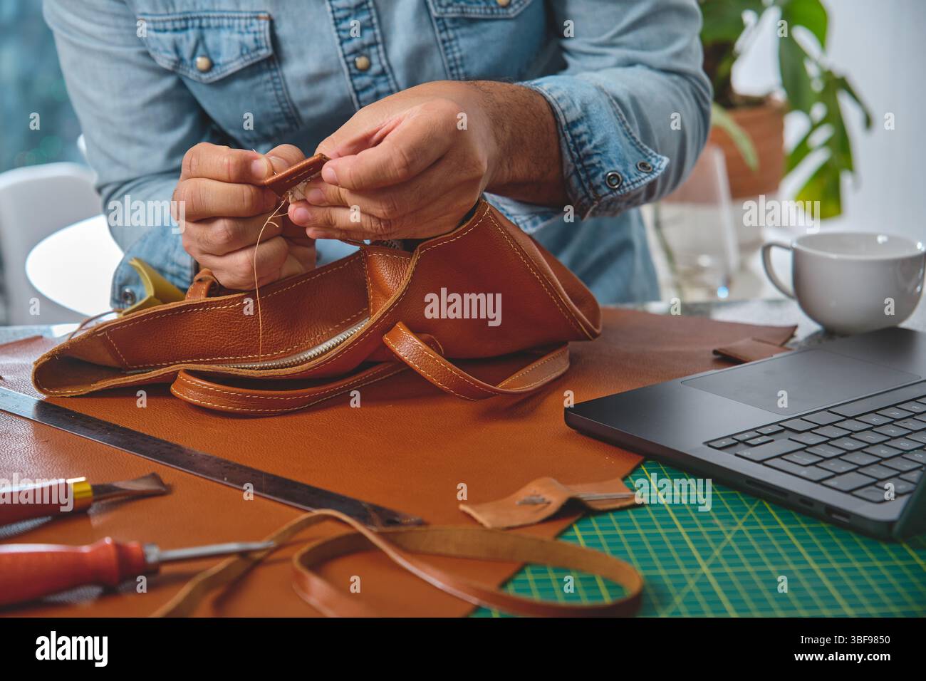 Leather craftsman producing leatherwork hi-res stock photography and ...