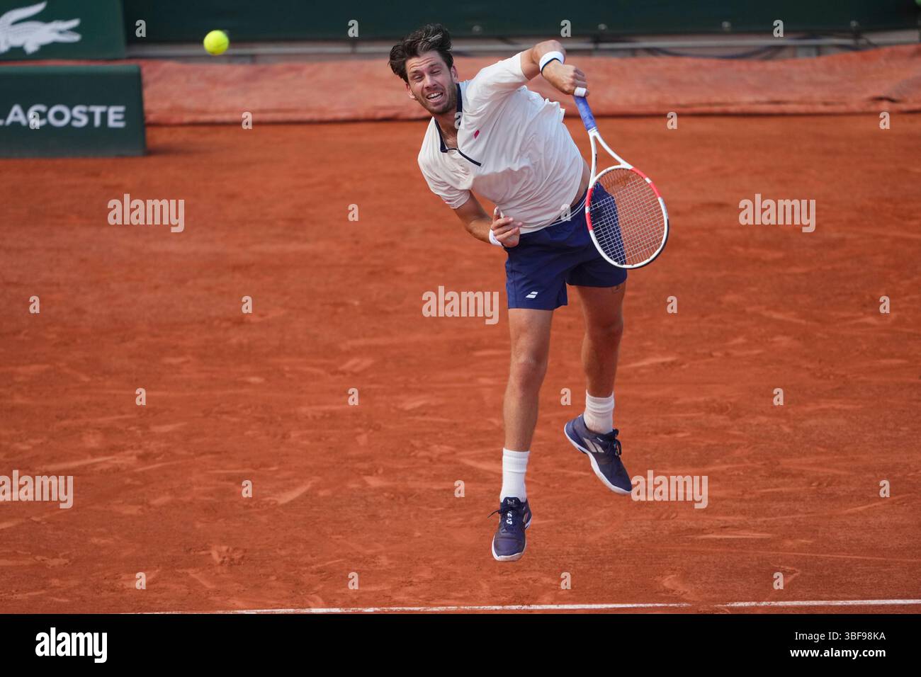 Britain's Cameron Norrie serves against Britain's Jacob Fearnley during ...