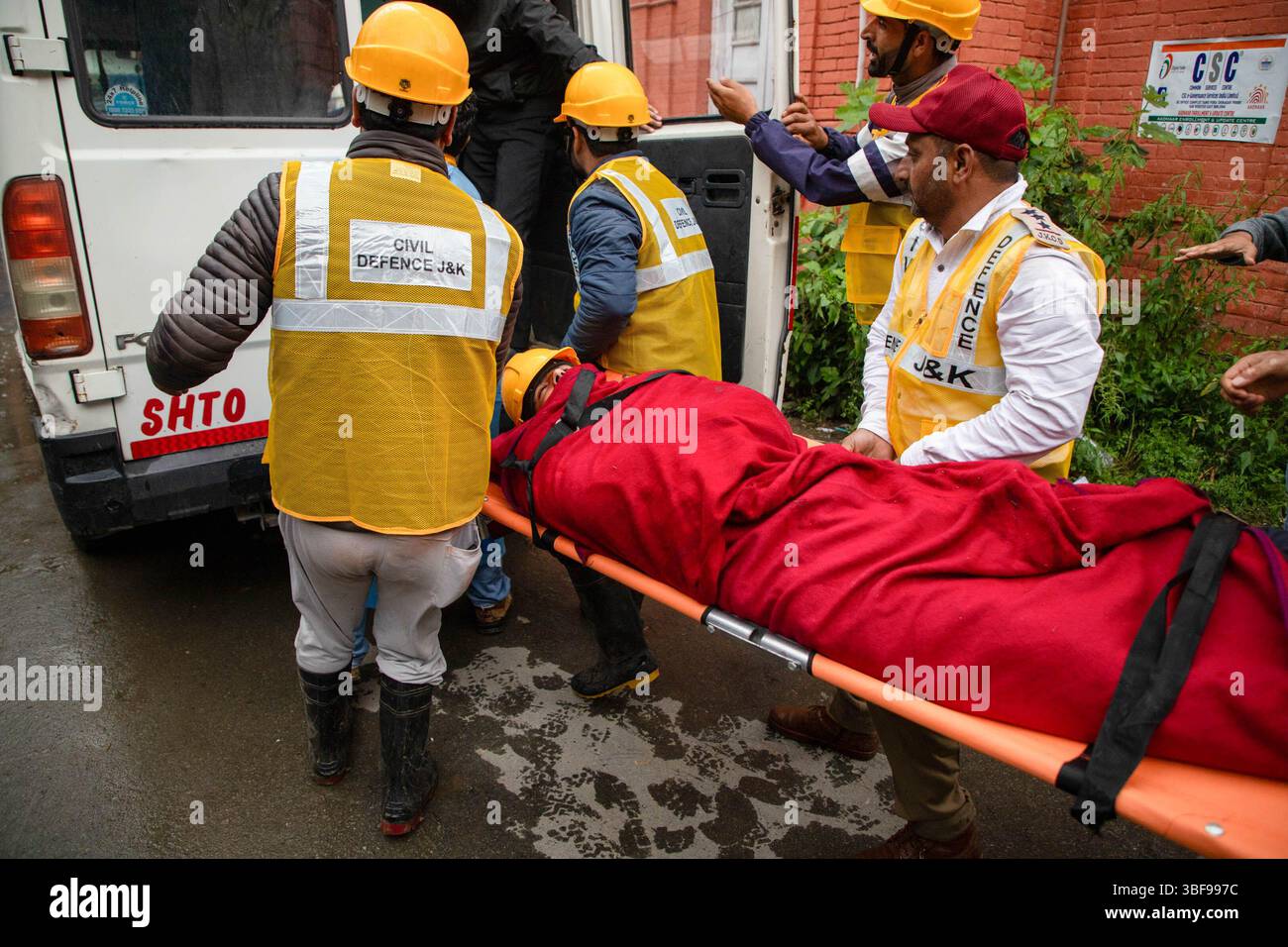 Civil Defence workers carrying a body on stretcher as they participate ...
