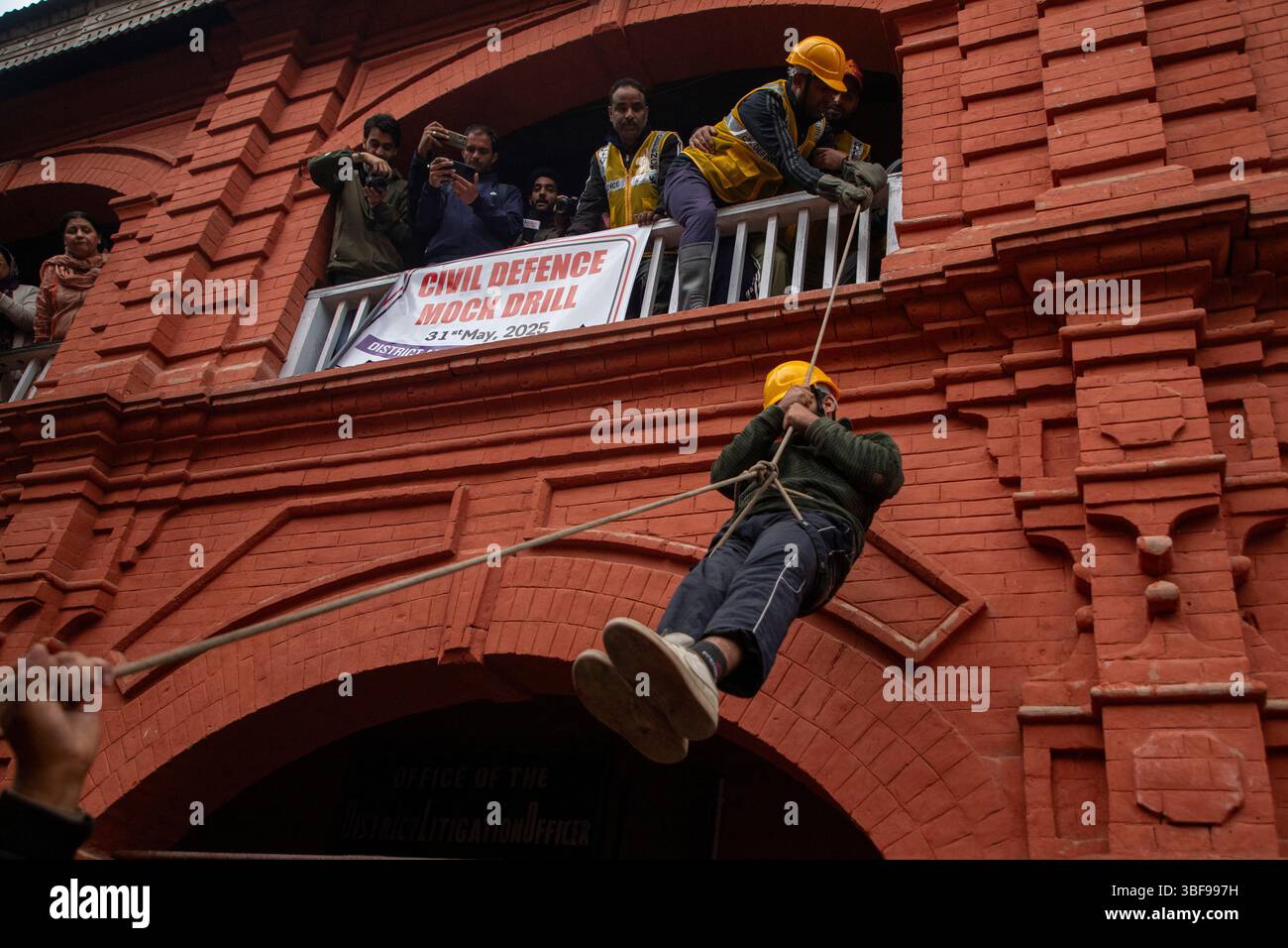 A Firefighter comes down with the help of a rope as he participates in ...