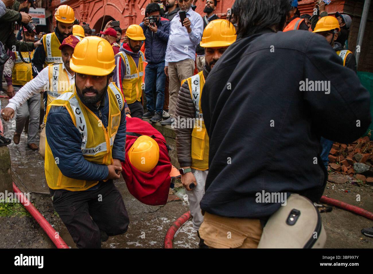 Civil Defence workers carrying a body on stretcher as they participate ...