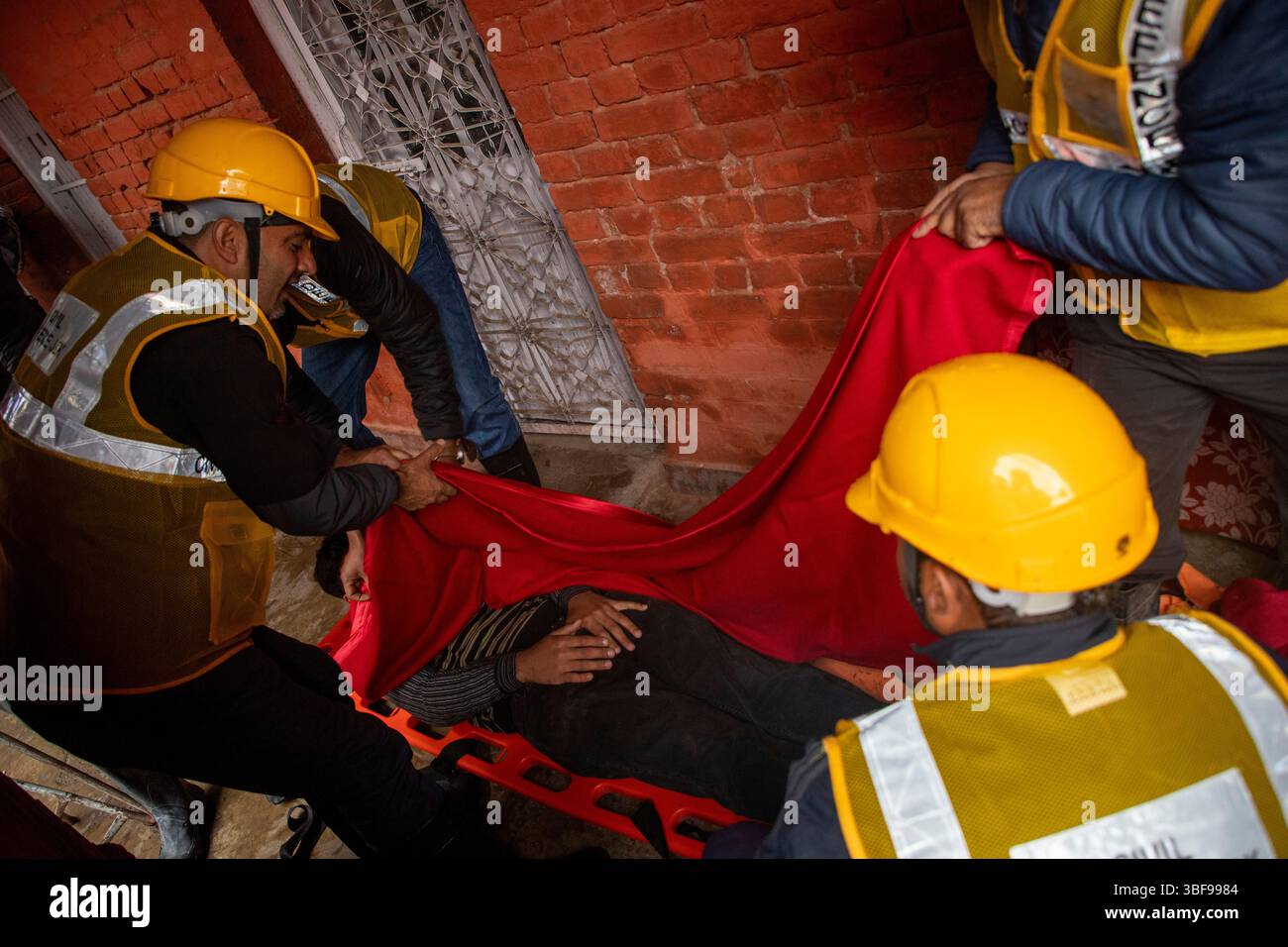 Civil Defence workers carrying a body on stretcher as they participate ...