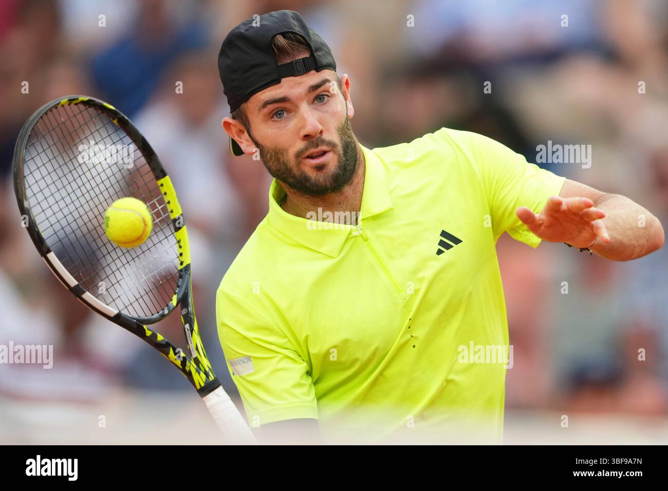 Britain's Jacob Fearnley returns the ball to Britain's Cameron Norrie ...