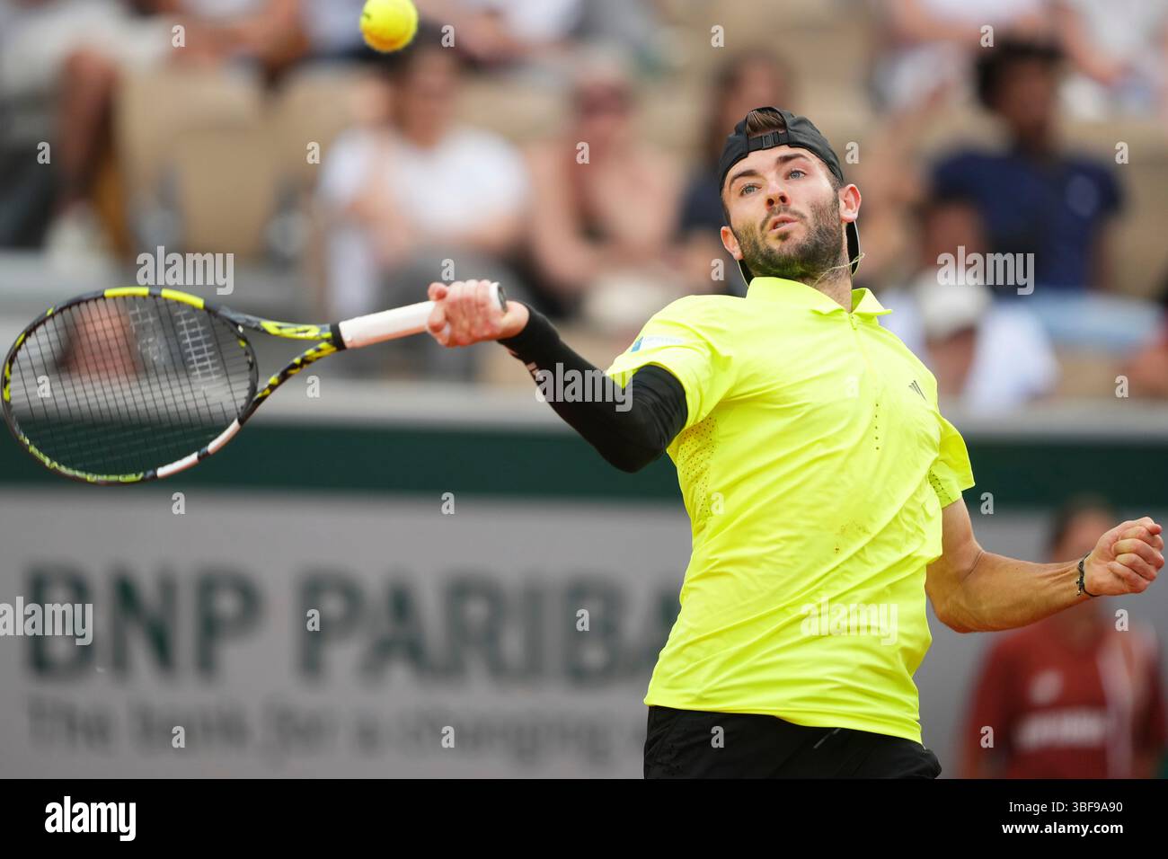 Britain's Jacob Fearnley returns the ball to Britain's Cameron Norrie ...