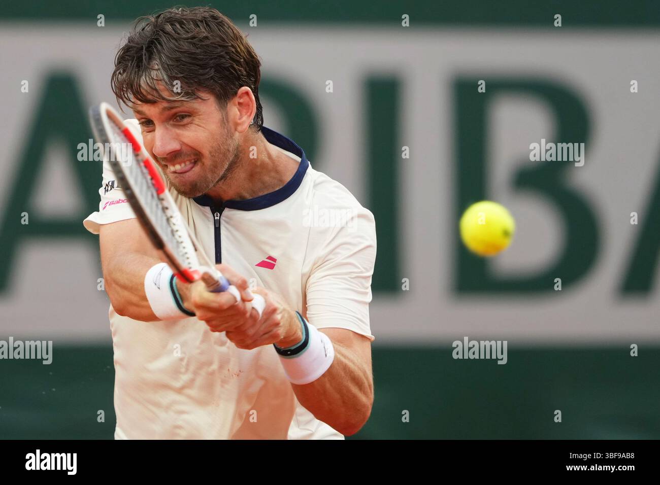 Britain's Cameron Norrie returns the ball to Britain's Jacob Fearnley ...
