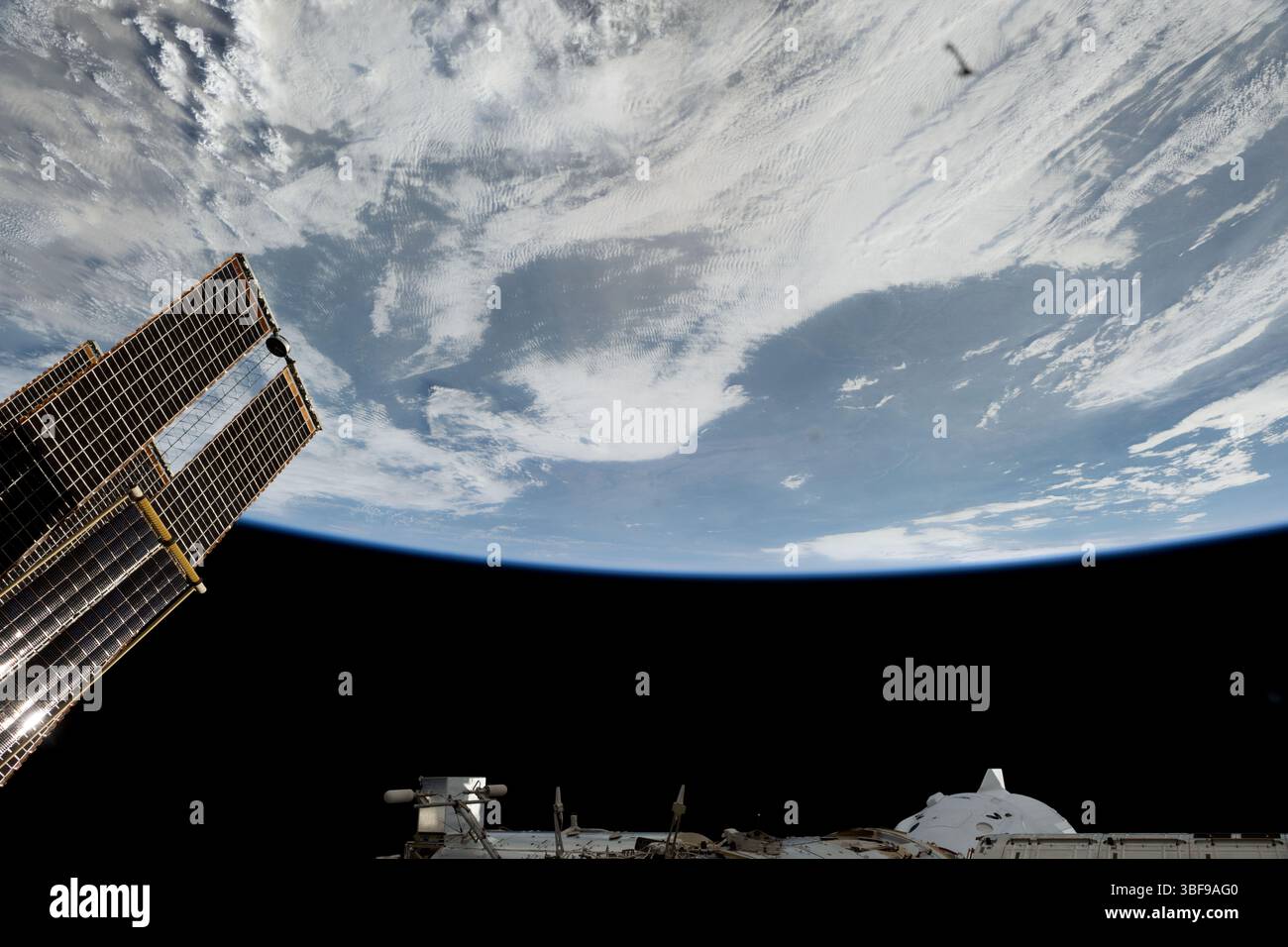 Partially obscured, at bottom right, is the SpaceX Dragon crew ...