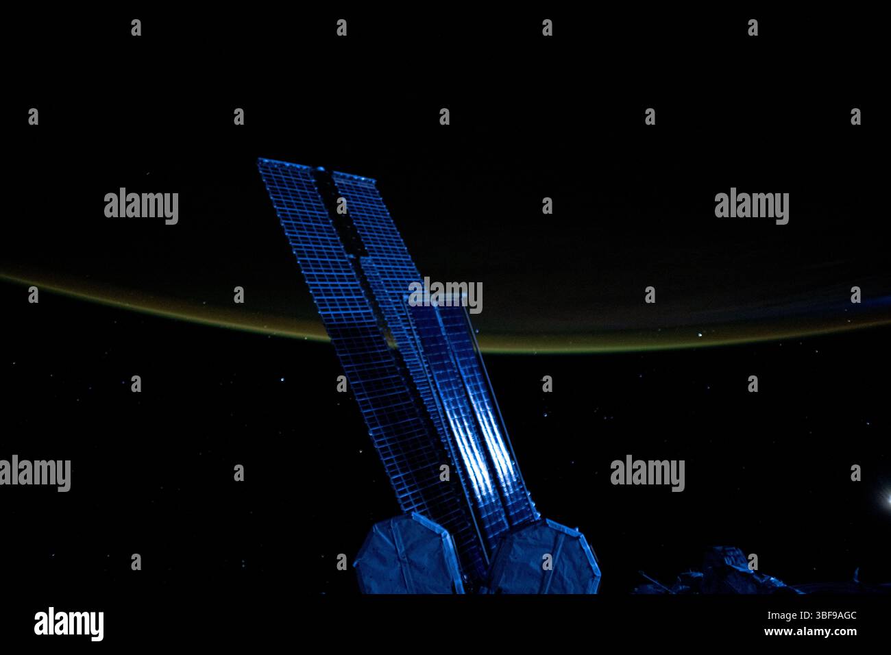 Moonlight casts a blue light on a set of the International Space ...