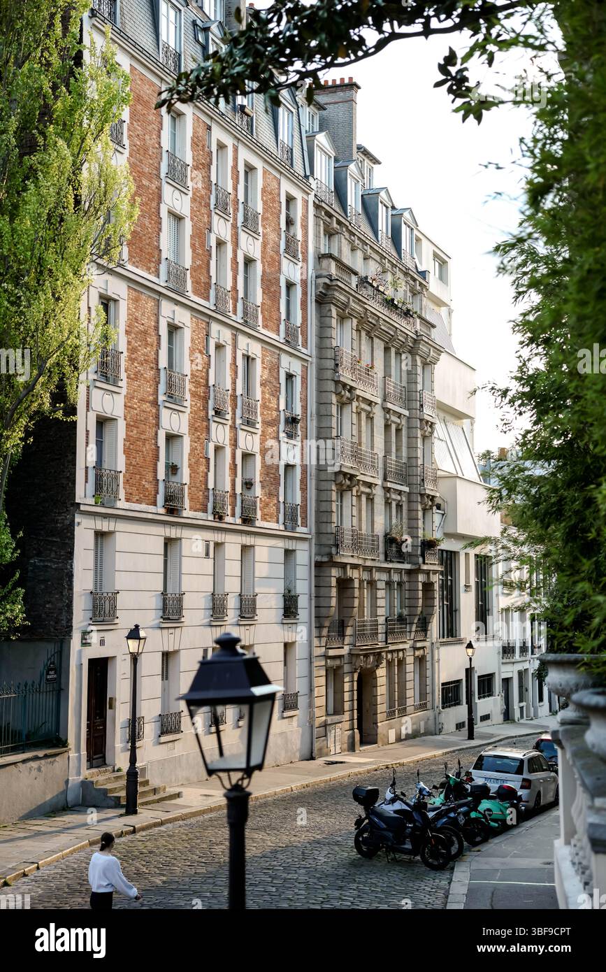 A Parisian street view featuring classic apartment buildings, one with ...