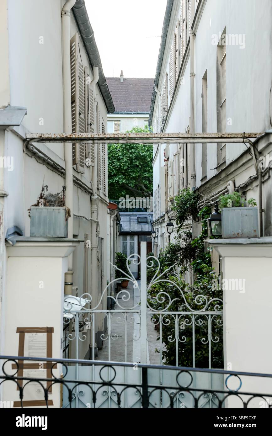 A perspective down a very narrow passage or alleyway between tall ...