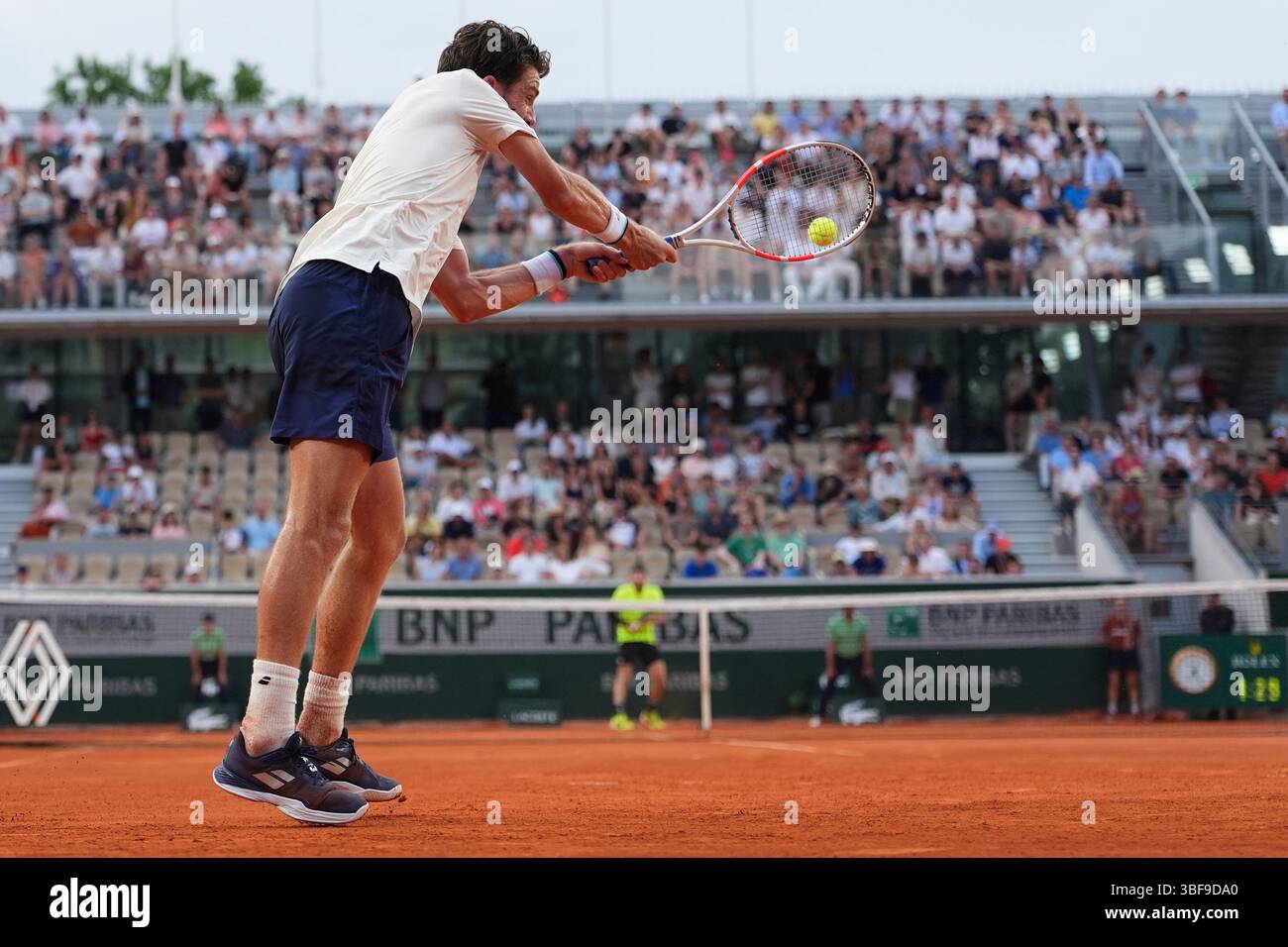 Britain's Cameron Norrie returns the ball to Britain's Jacob Fearnley ...