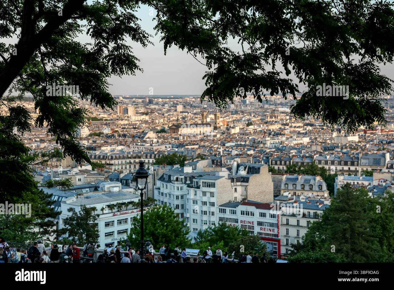 A view overlooking a crowded area in Montmartre and the Paris cityscape ...