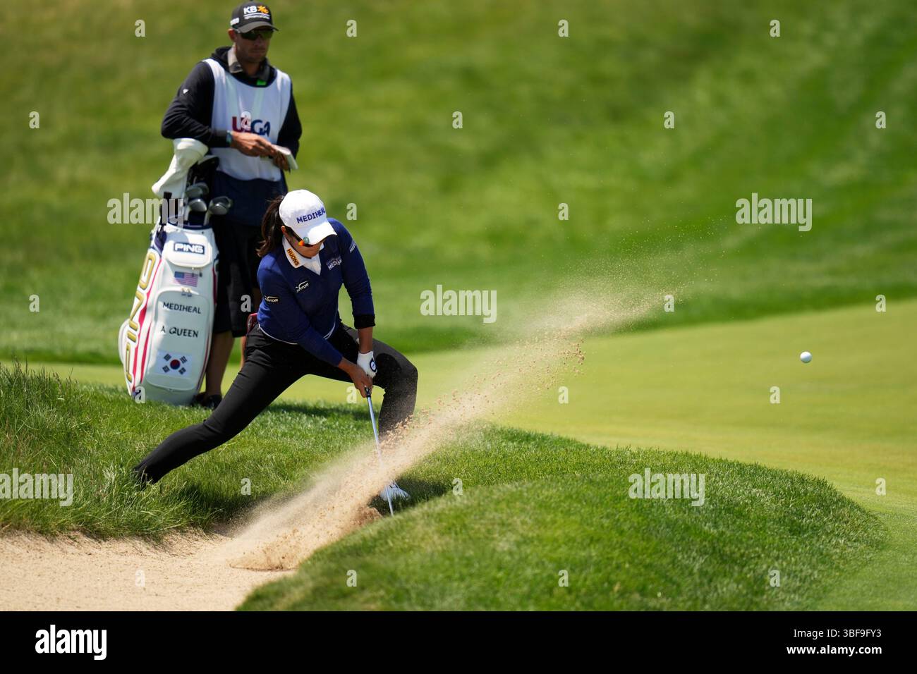 A Lim Kim, of South Korea, hits from the bunker on the fifth hole ...
