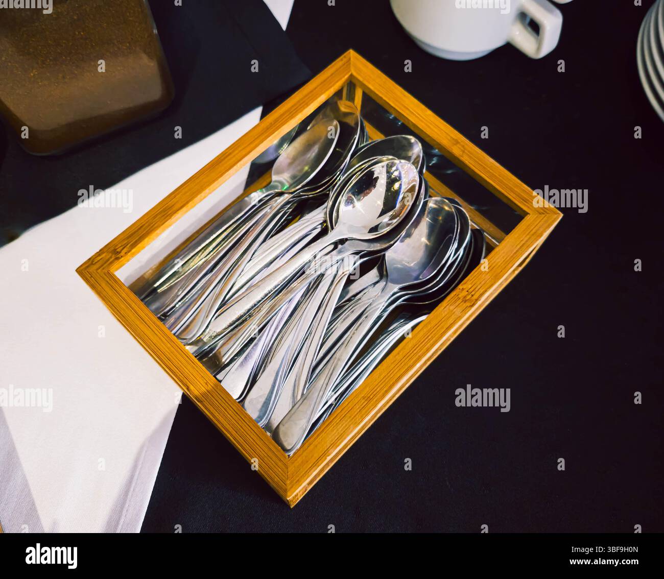 Metal teaspoons in a wooden box – catering utensils setup Stock Photo ...