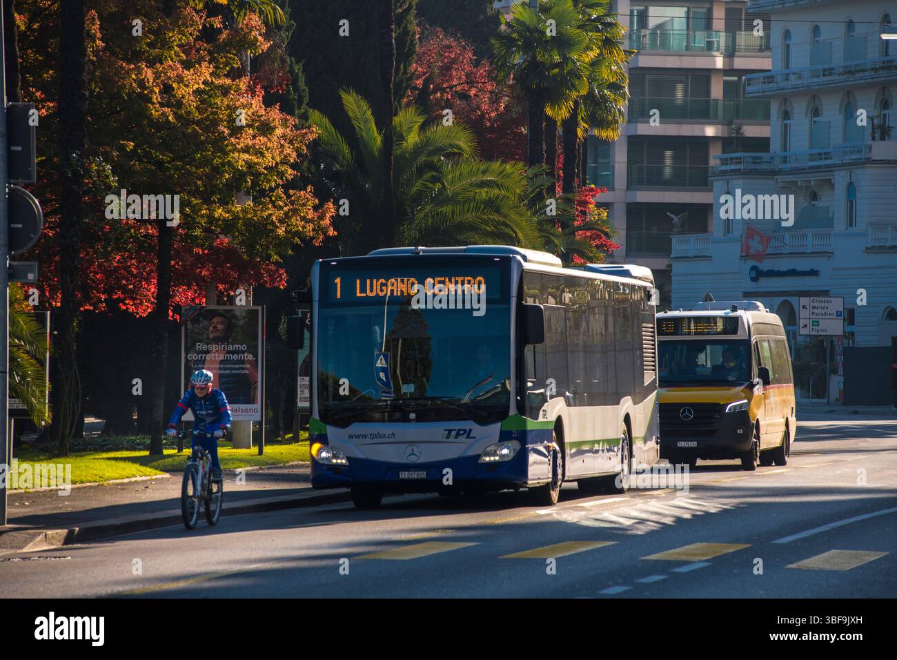 Cyclist and buses on the road, Lugano, Canton Ticino, Switzerland Stock ...