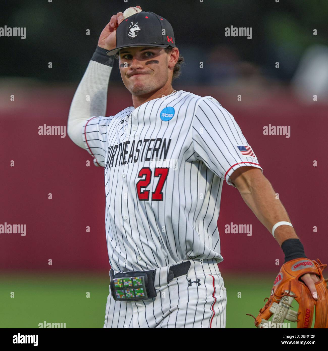 Northeastern infielder Jack Doyle (27) warms up before an NCAA regional ...