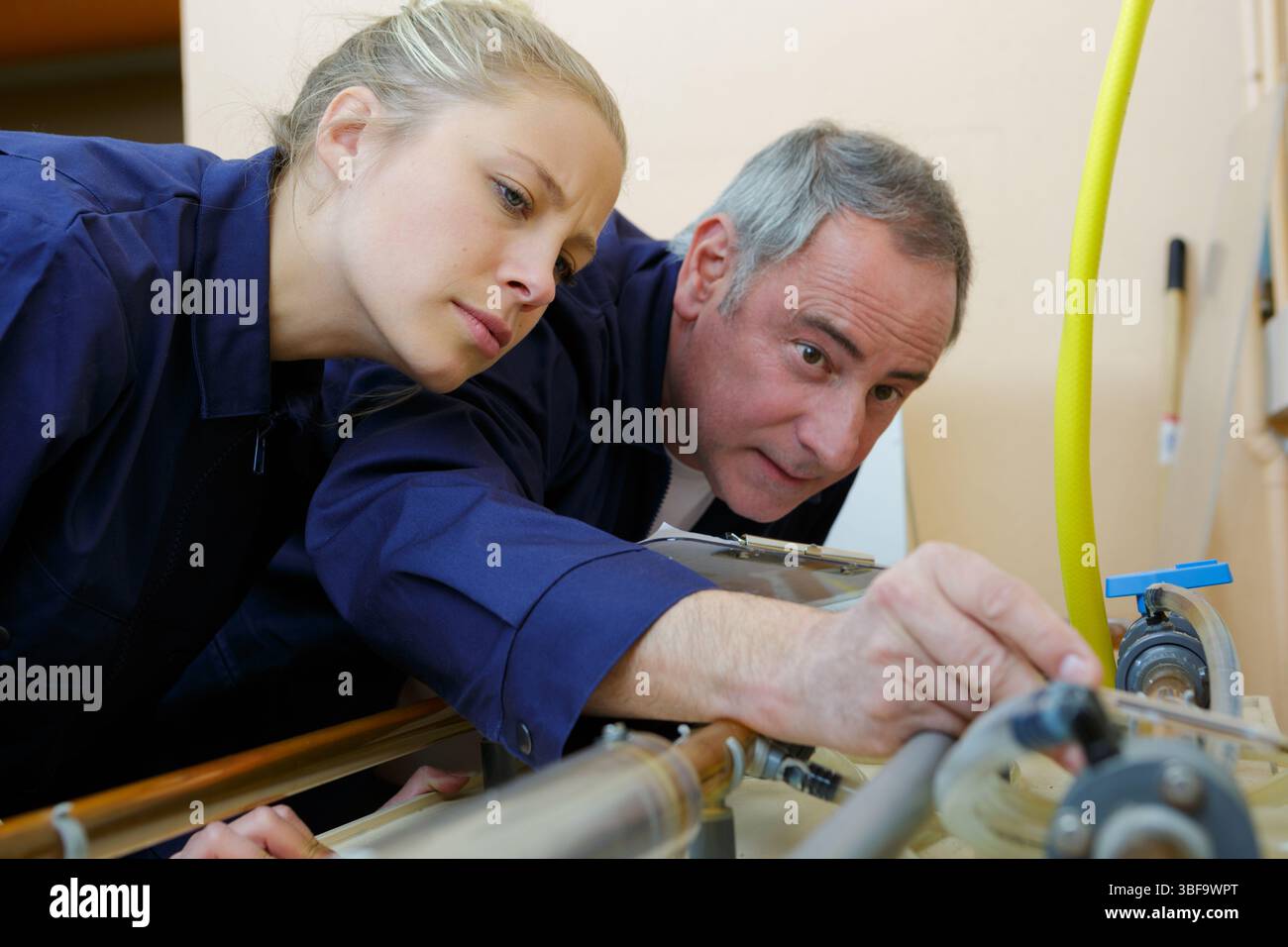 two technicians working with cables Stock Photo - Alamy
