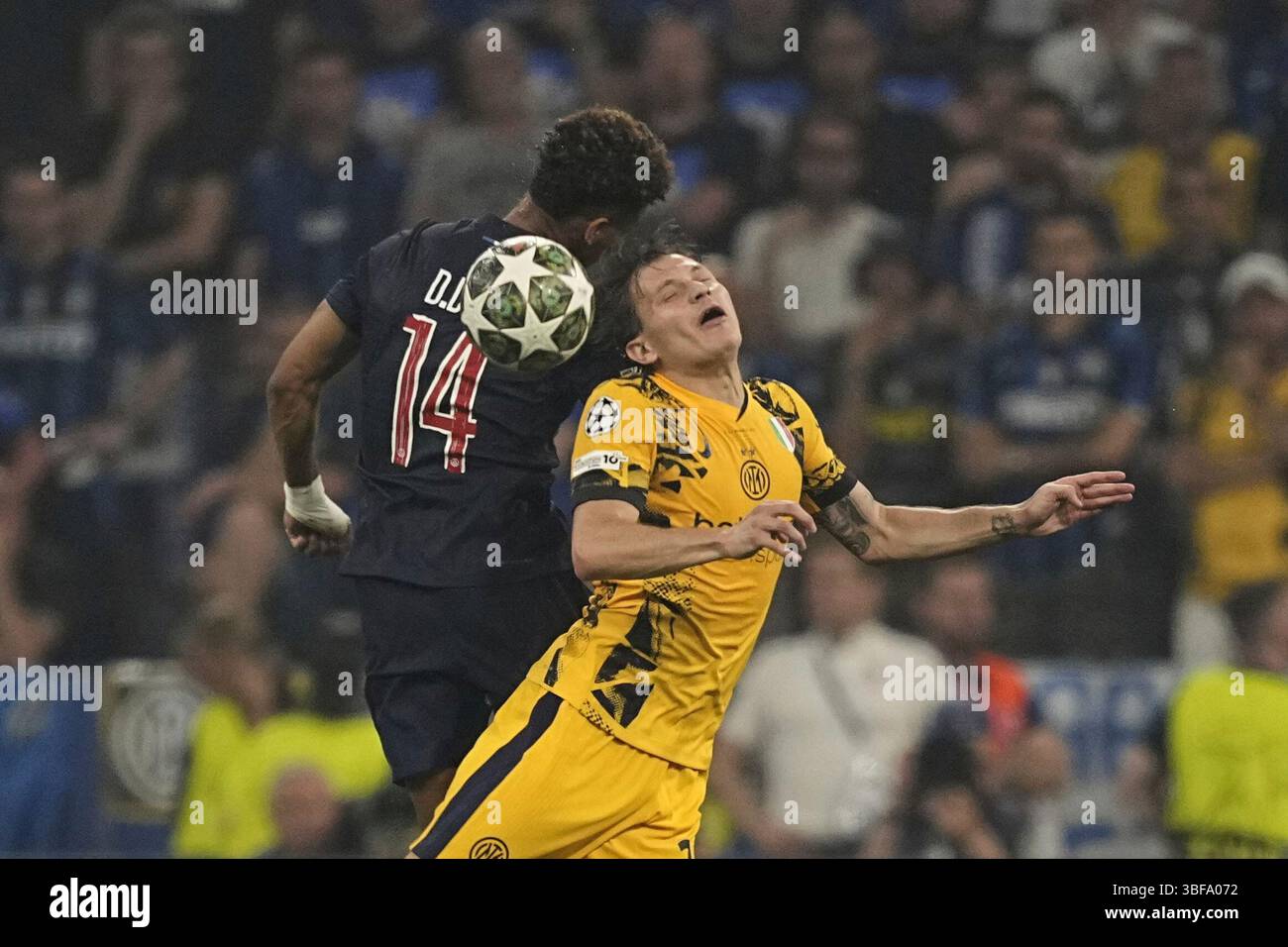 PSG's Desire Doue, left, jumps for the ball with Inter Milan's Nicolo ...
