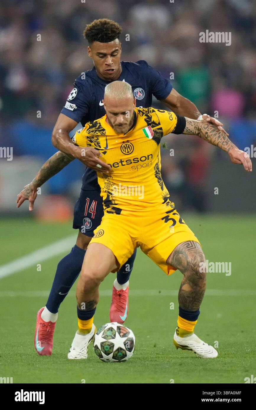 PSG's Desire Doue, top, challenges for the ball with Inter Milan's ...