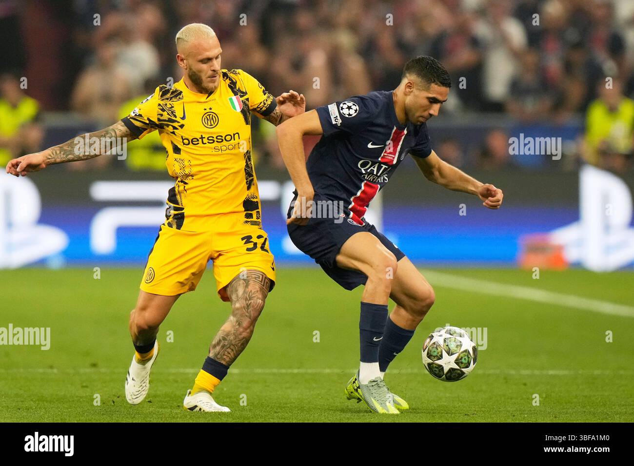 PSG's Achraf Hakimi shields the ball from Inter Milan's Federico ...
